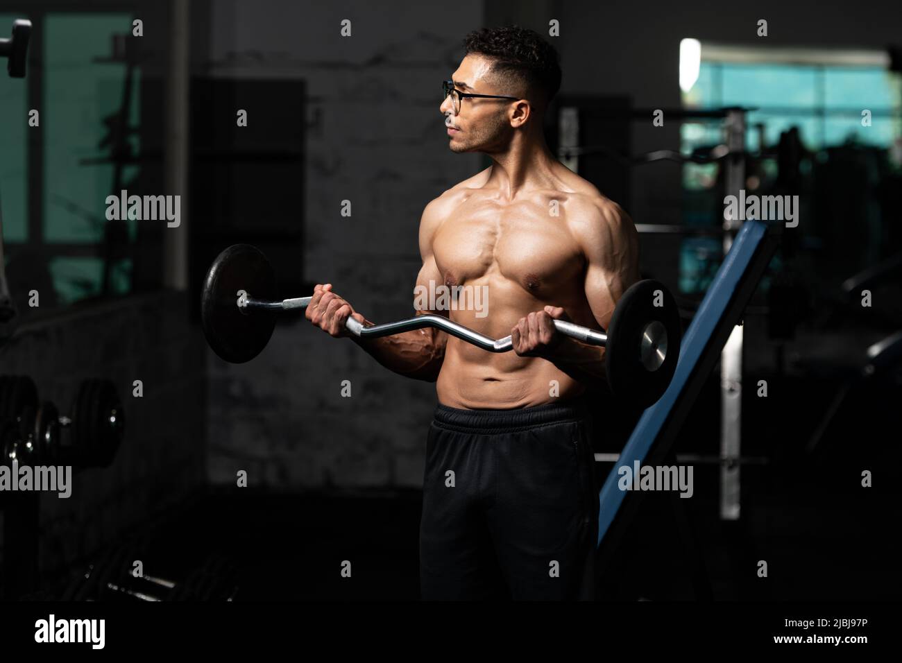 Man With Gynecomastia Breasts Problem Working Out Biceps In A Gym Stock ...