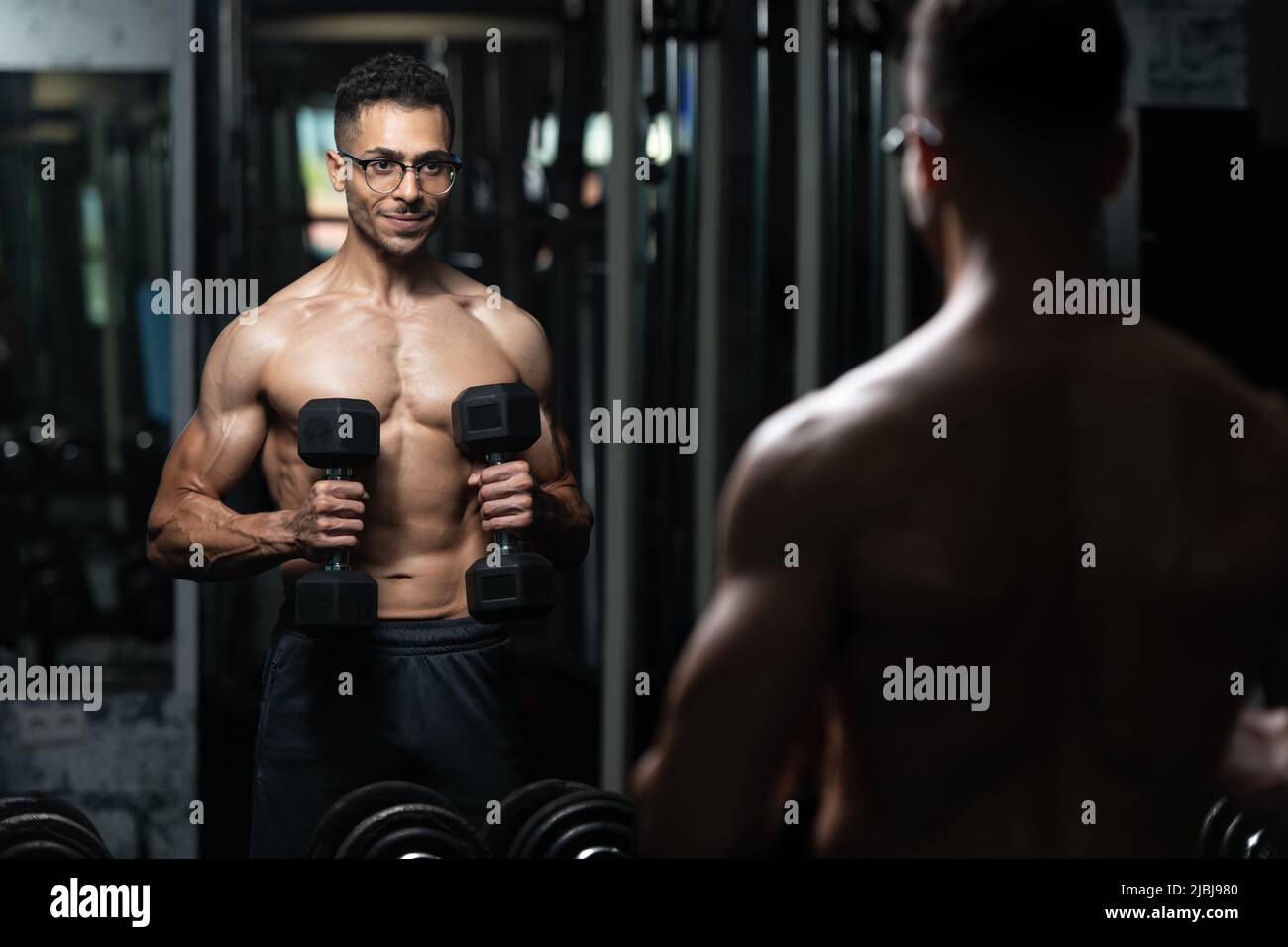 Athlete With Gynecomastia Breasts Problem Working Out Biceps In A Gym ...