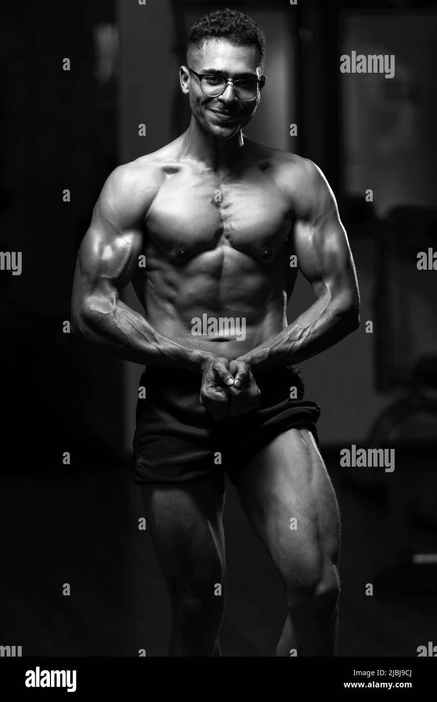 Young Man With Gynecomastia Breasts Problem Standing Strong In The Gym ...