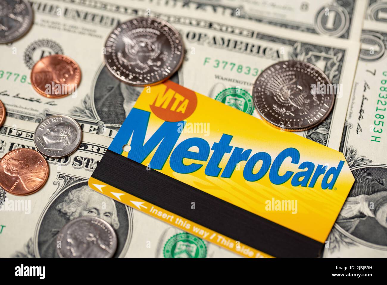 Manhattan, New York/USA - April 8. 2021: Metrocard with dollar coins ...