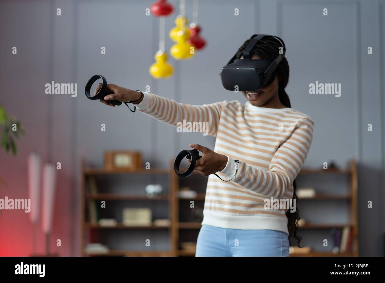 Happy young african american woman wearing virtual reality goggles ...