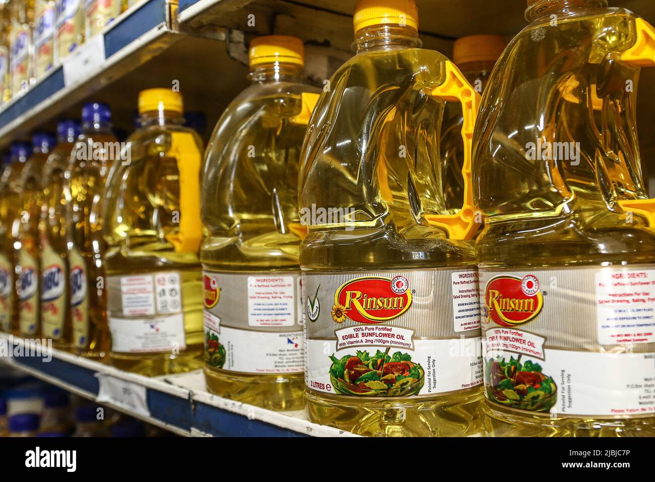 Plastic bottles of vegetable oil seen on a shelf at a local supermarket ...