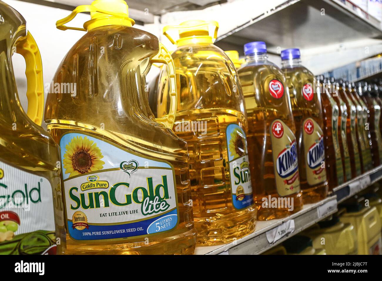 Plastic bottles of vegetable oil seen on a shelf at a local supermarket ...