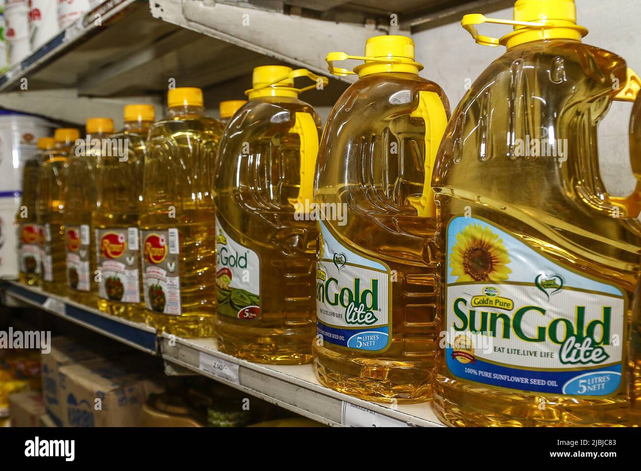 Plastic bottles of vegetable oil seen on a shelf at a local supermarket ...