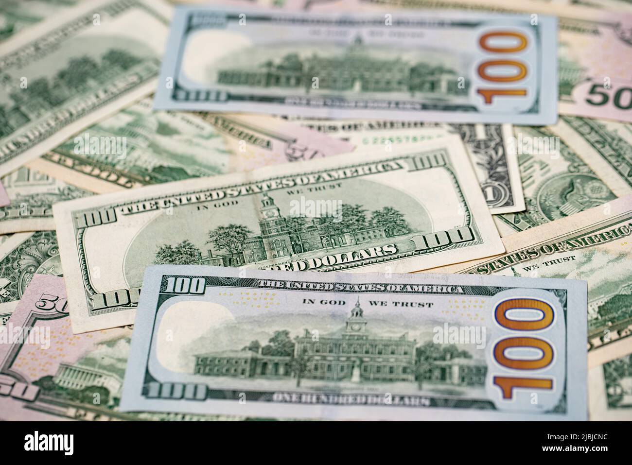 US dollar banknotes as background. One hundred dollar bills spread out ...