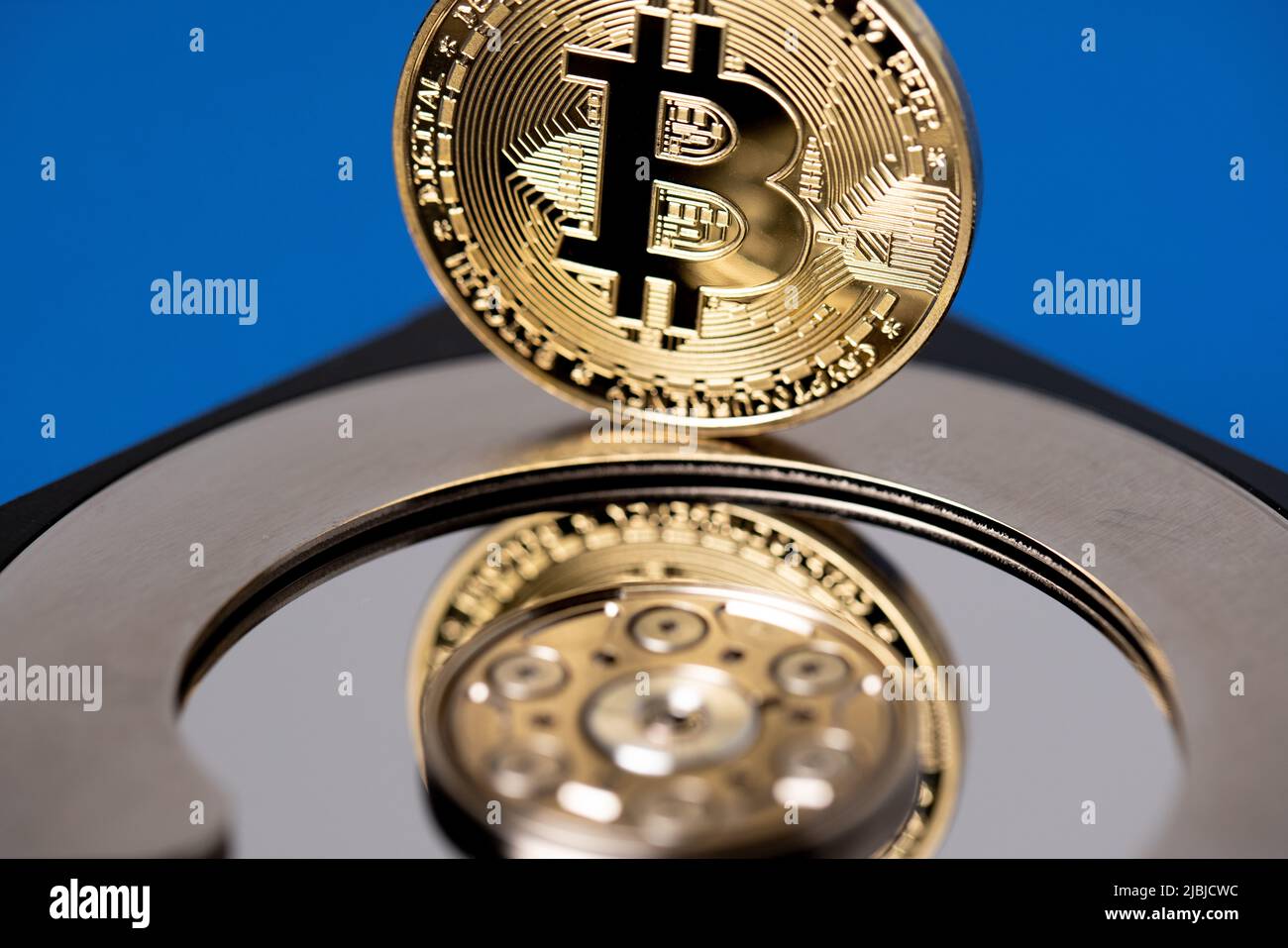 Bitcoin reflecting on hard drive platter. Digital technology and ...