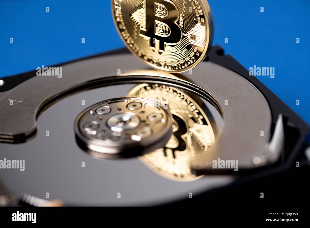 Bitcoin reflecting on hard drive platter. Digital technology and ...