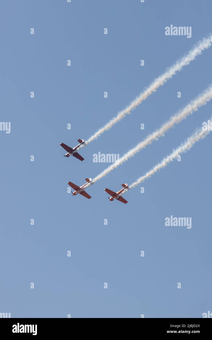 Three colorful jets flying in the sky and performing a show leaving ...