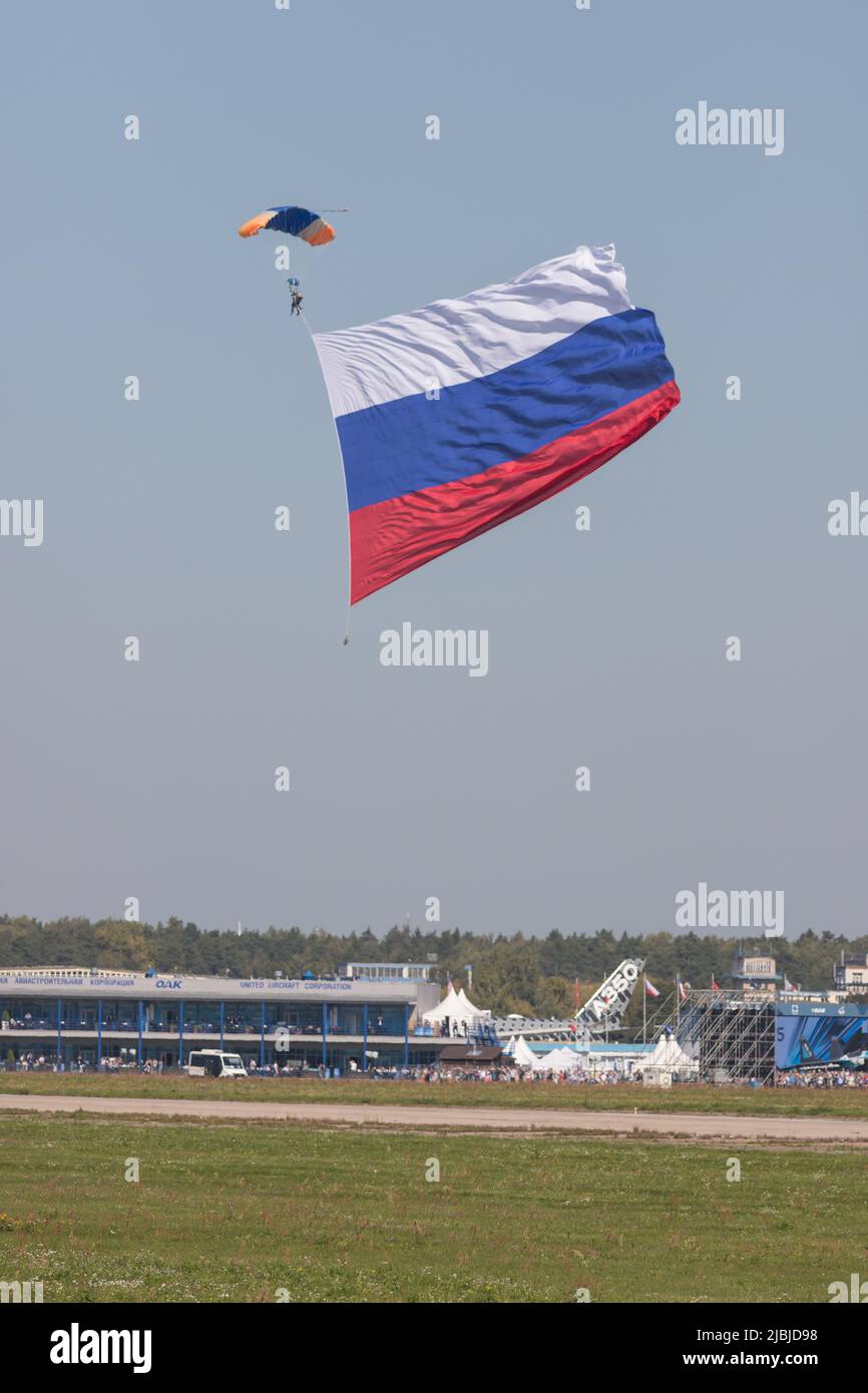 29 AUGUST 2019 MOSCOW, RUSSIA: A man flying in the sky with opened ...