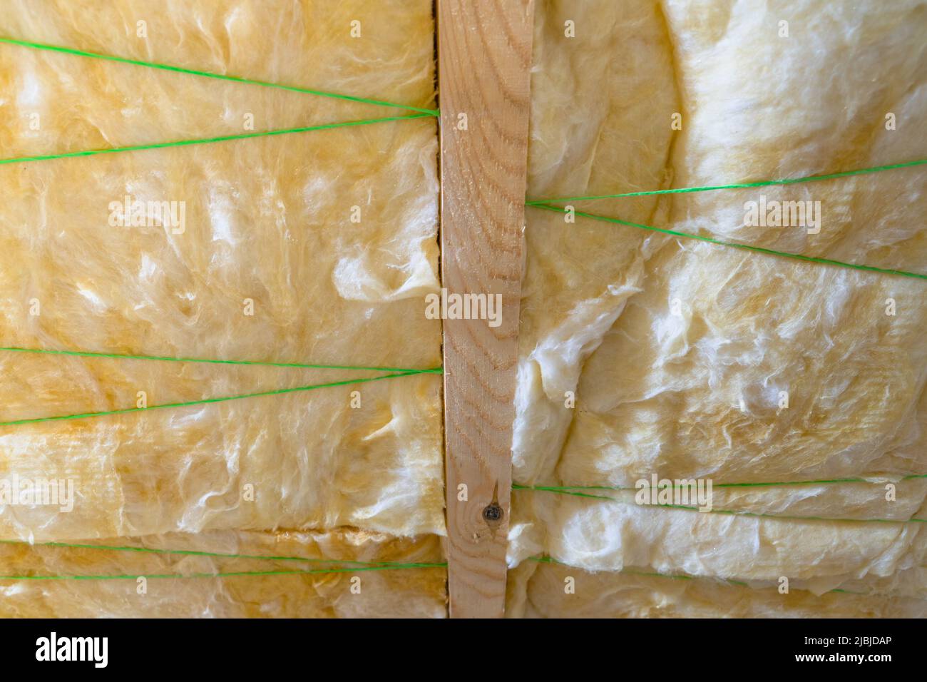 Glass roof insulation. Twine plastic thread supports the insulation ...