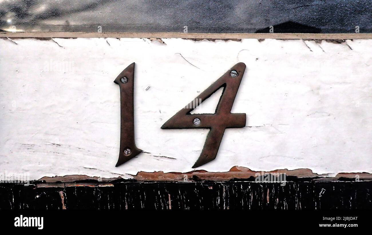 Street address 14 in jaunty metal numbers on worn wood surfaces Stock ...