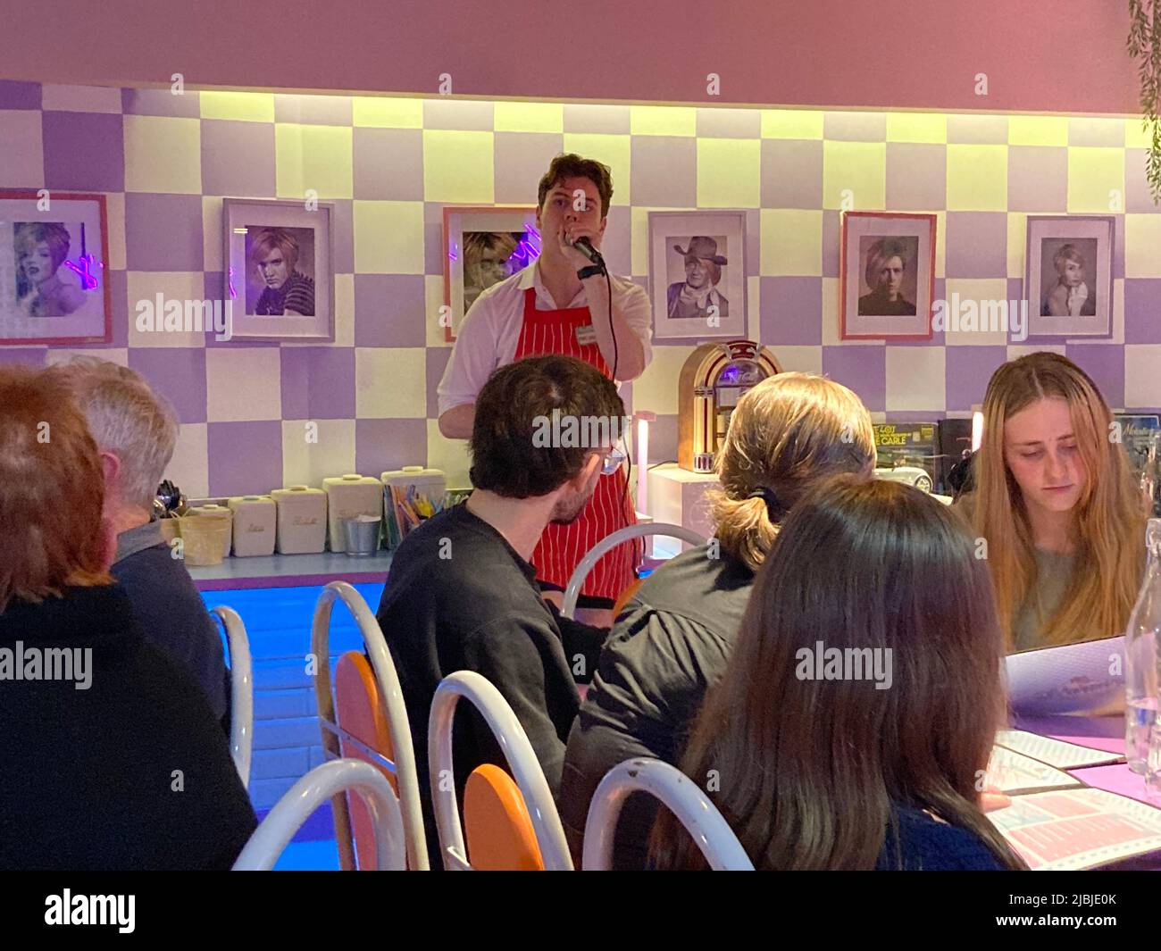 Sydney, Australia. 25th May, 2022. A waiter in a red-and-white apron ...