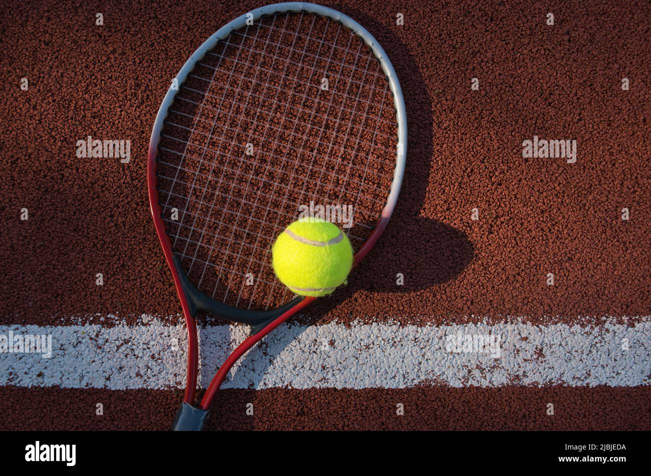 Top view tennis scene with ball, racquet on hard tennis court surface ...
