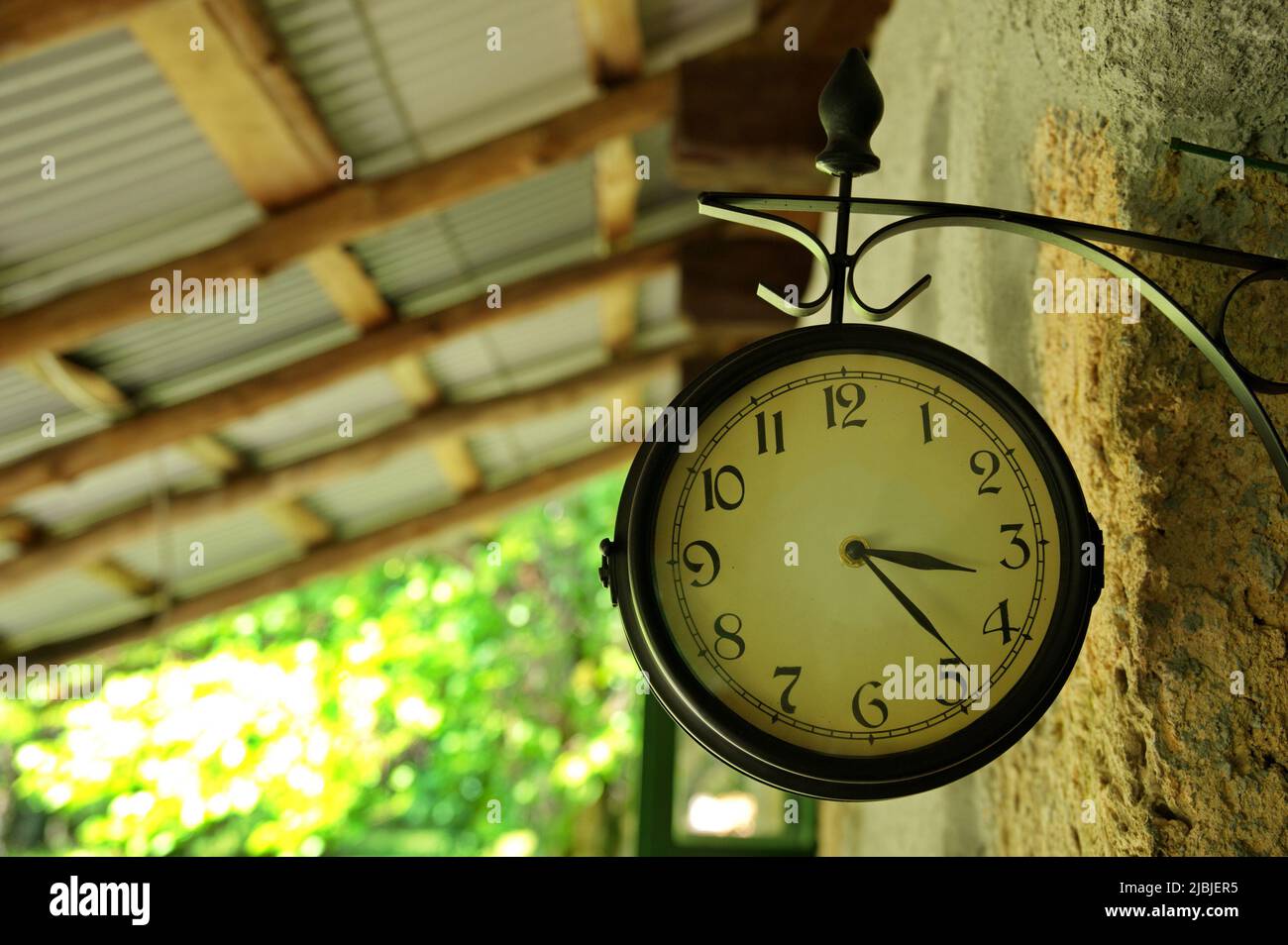 Big old clock on the wall of stone house in nature Stock Photo - Alamy