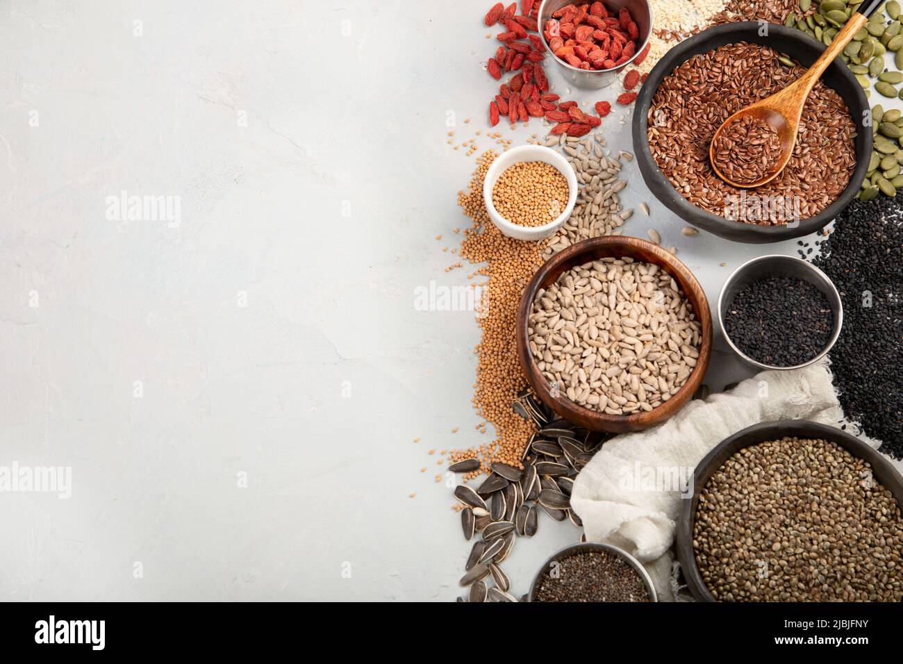 Variety of edible seeds on light background. Cereal and grains. Healthy ...