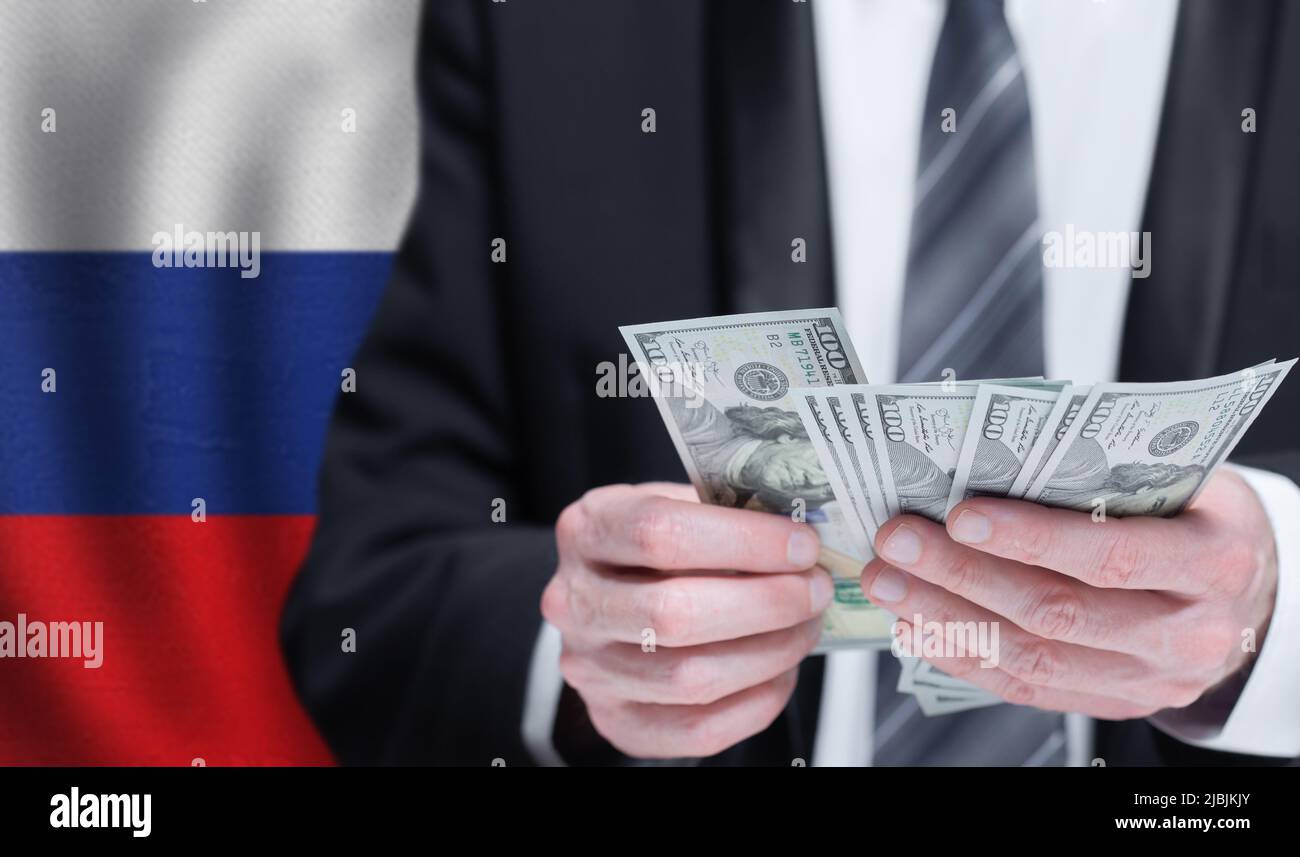 Hands holding dollar money on flag of Russia Stock Photo - Alamy