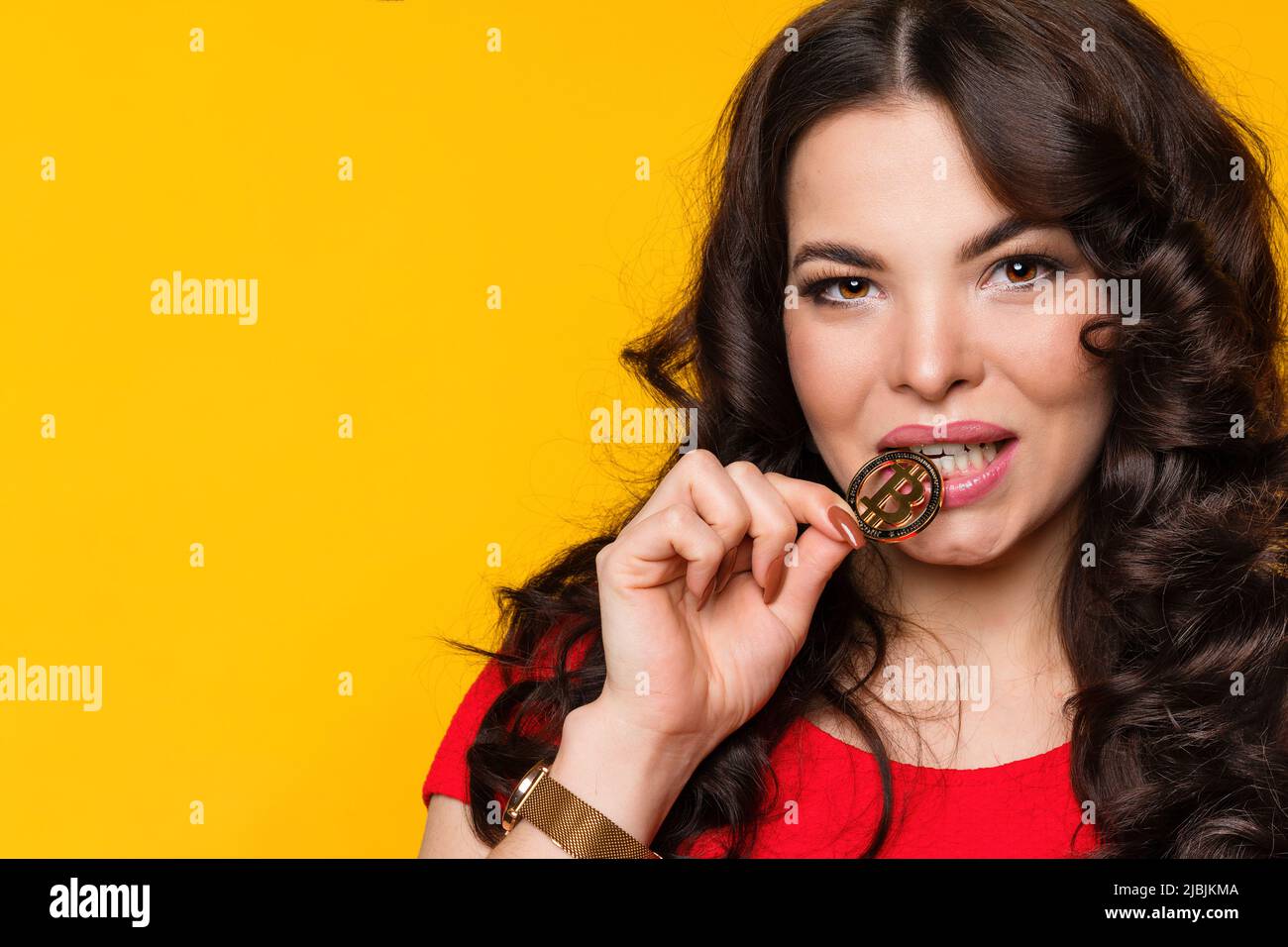 Try cryptocurrency and blockchain. Girl biting btc coin and blinks eye ...