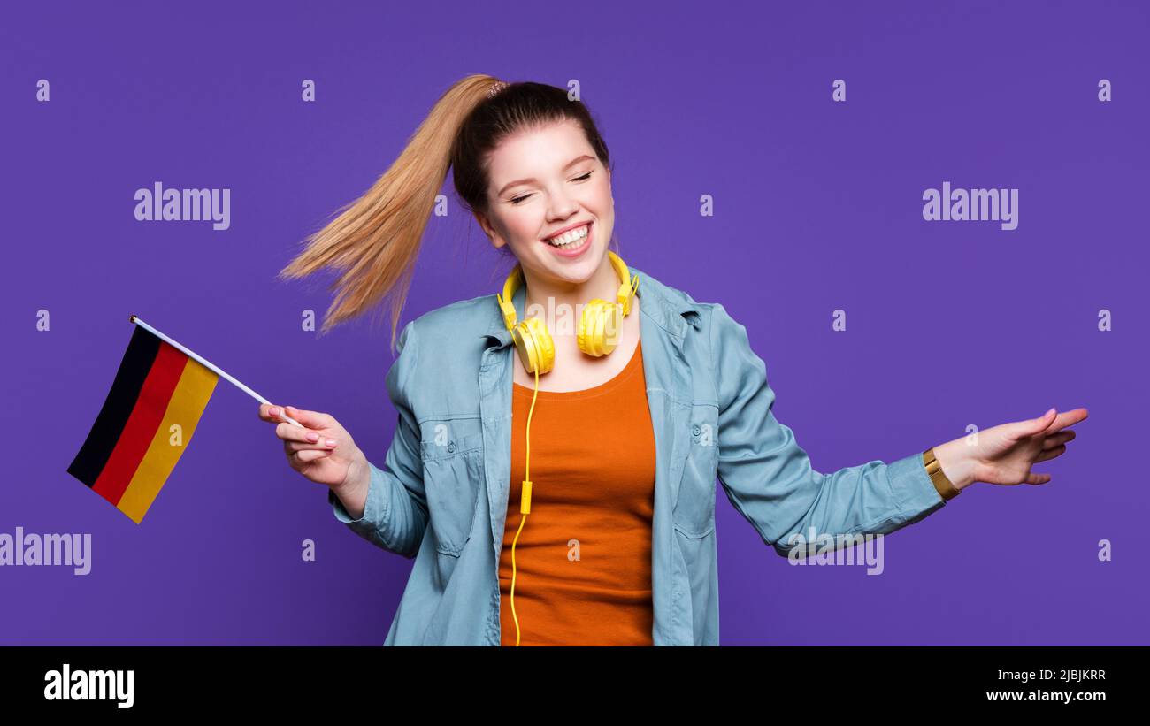 Closed eyes Laughing Girl in casual clothes and headphones holds small ...
