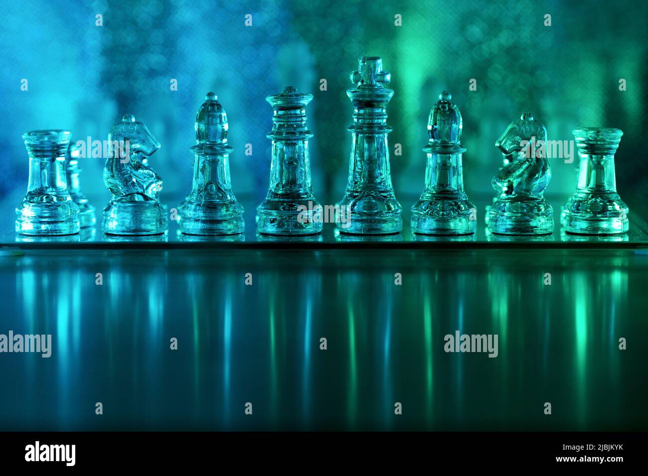 Transparent translucent pieces are placed on chessboard. Concept of ...