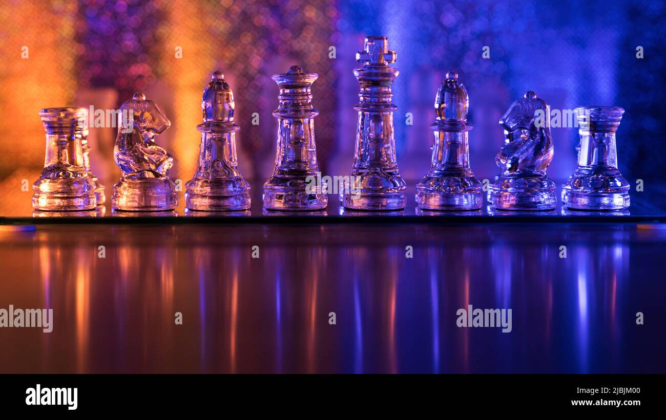 Transparent translucent pieces are placed on chessboard. Concept ...