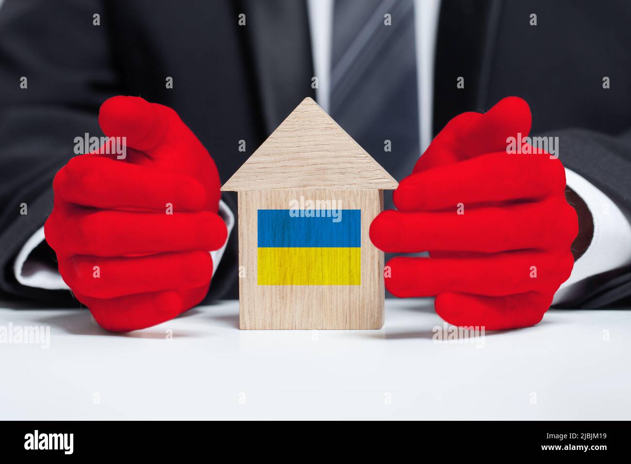 Bloody war hand near Ukrainian house Stock Photo - Alamy