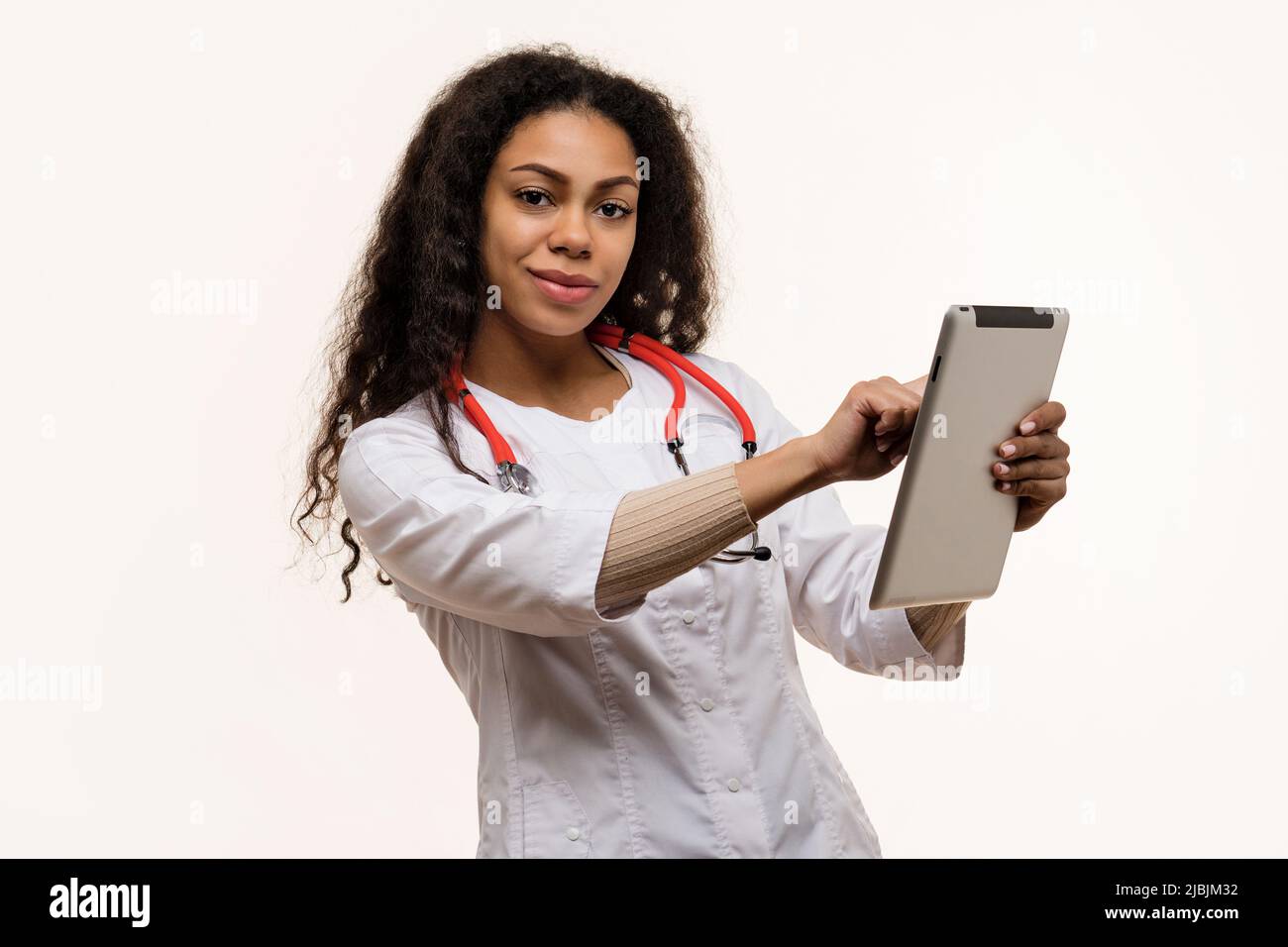 Dark Skinned Female General Doctor checking patient medical history in ...
