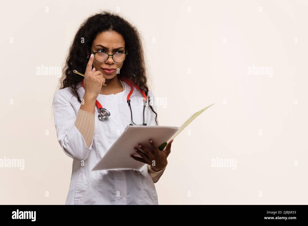 Emotional Puzzled Dark Skinned Female Doctor in Uniform with Glasses ...