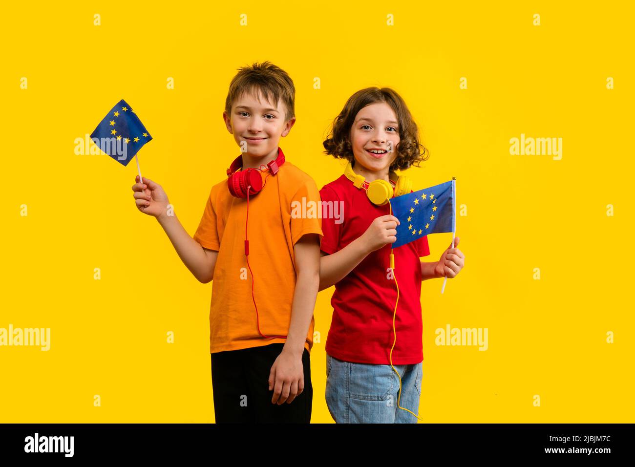 Two School Children with Headphones Hold European Union Flags. Concept ...