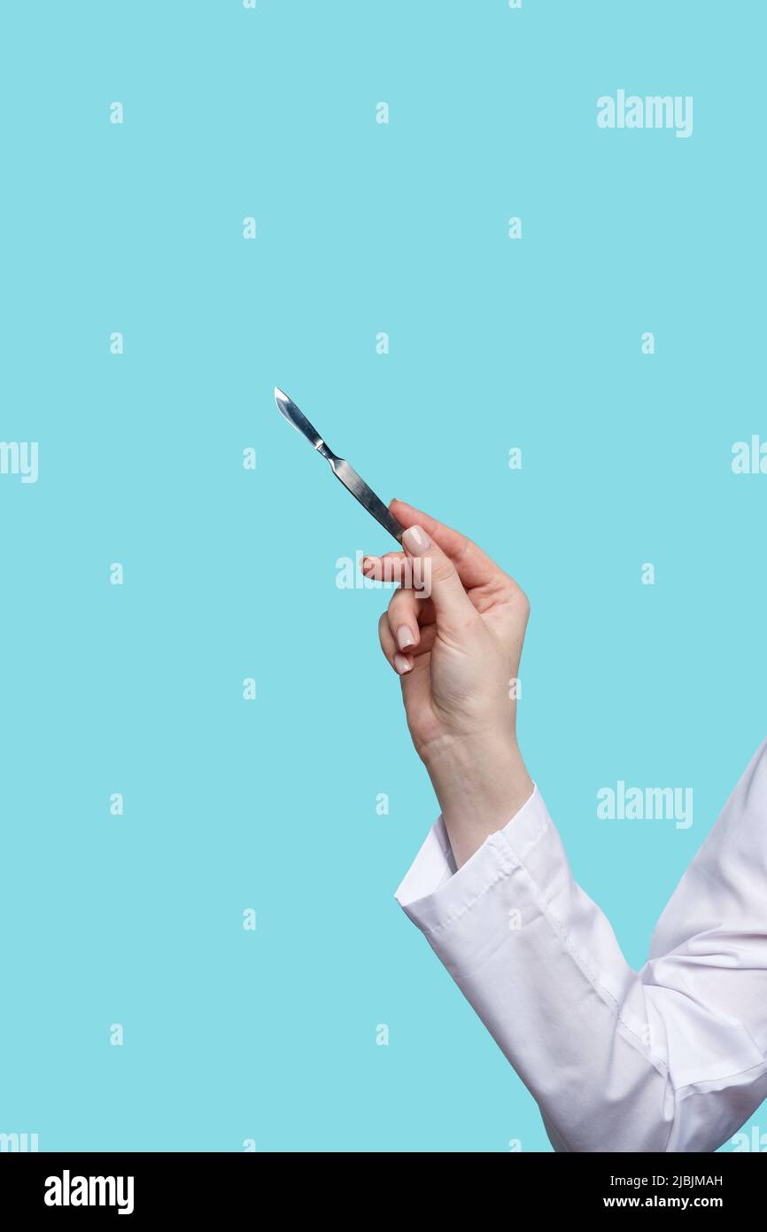 Unrecognizable female surgeon holding metal non-sterile surgical ...