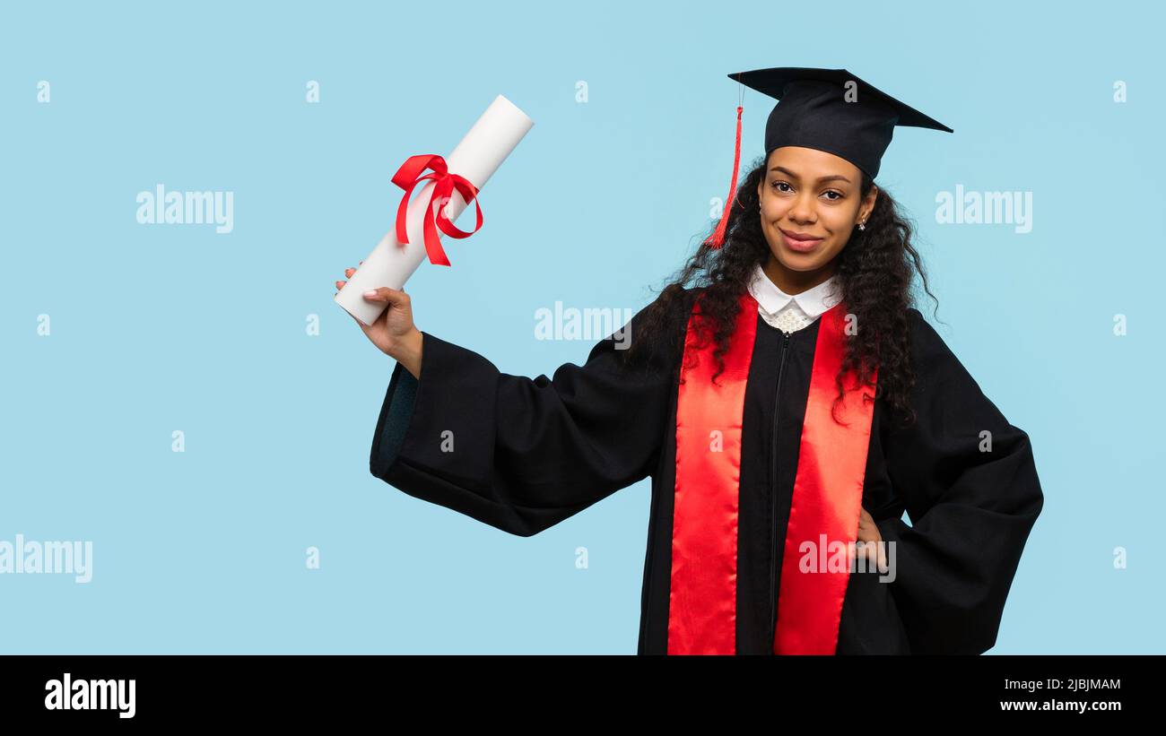 African American Female Graduate Wearing Ceremony Robe and Graduation ...