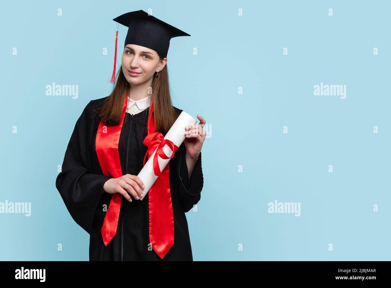 Joy Female Graduate Wearing Ceremony Robe and Graduation Cap Holding ...