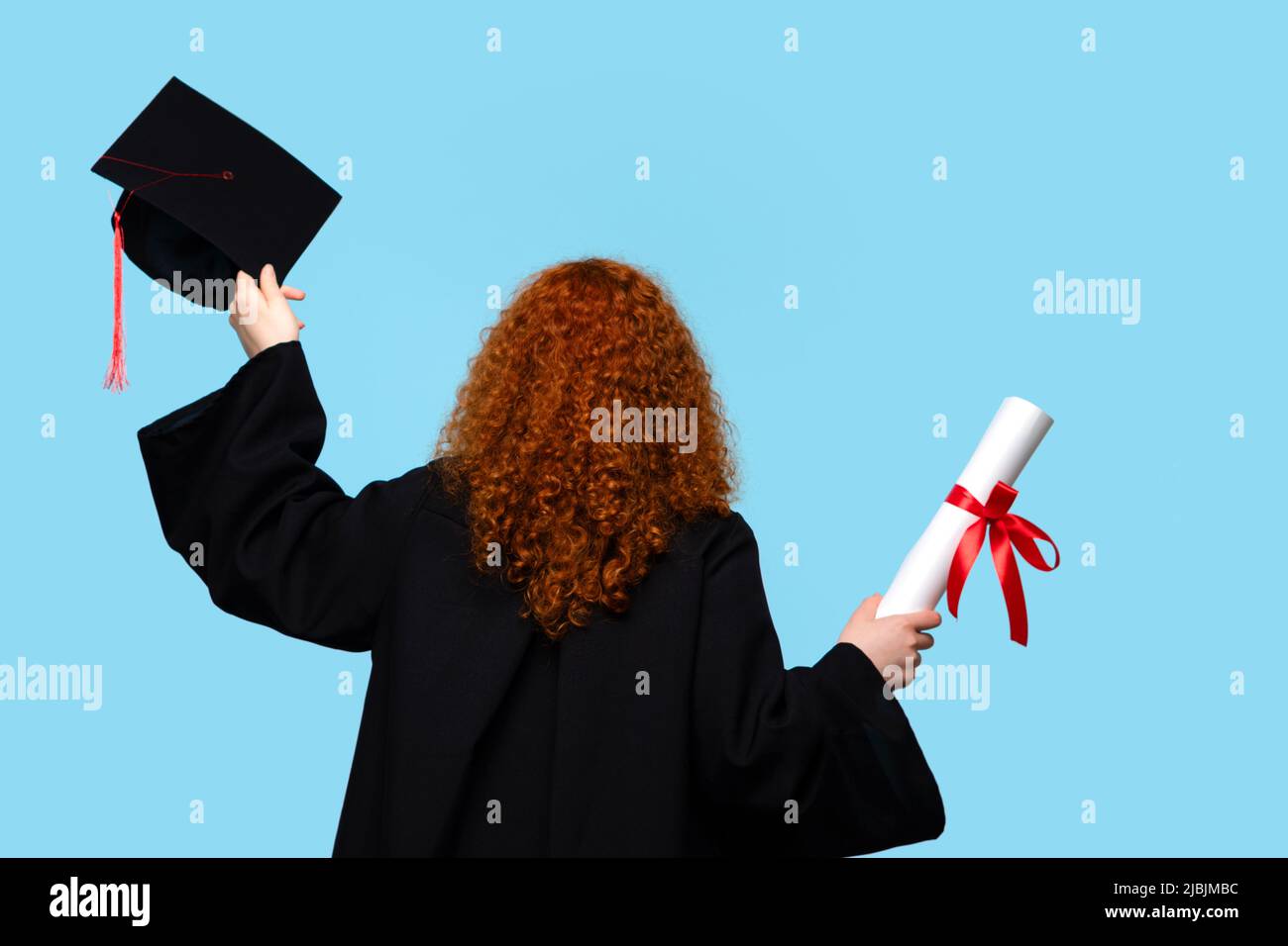 Female Graduate Wearing Ceremony Robe Holding Certificate and Throwing ...