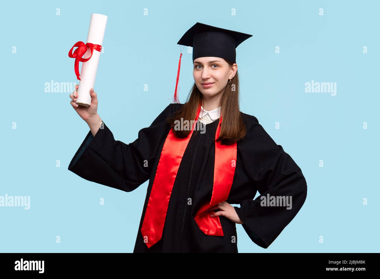 Proud Girl Graduate Wearing Ceremony Robe and Graduation Cap Holding ...
