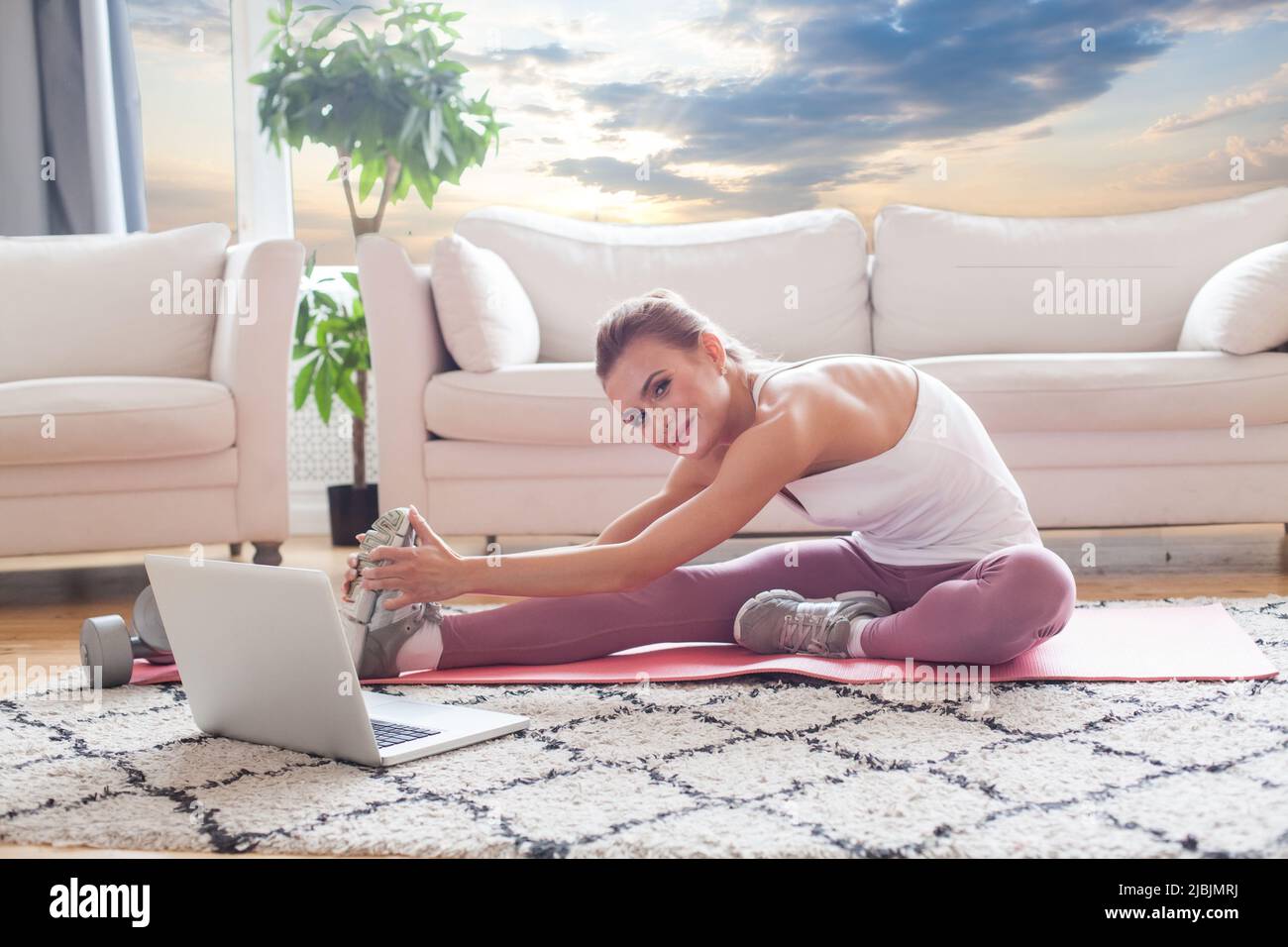 Portrait of amazing young beautiful fitness woman make stretching ...