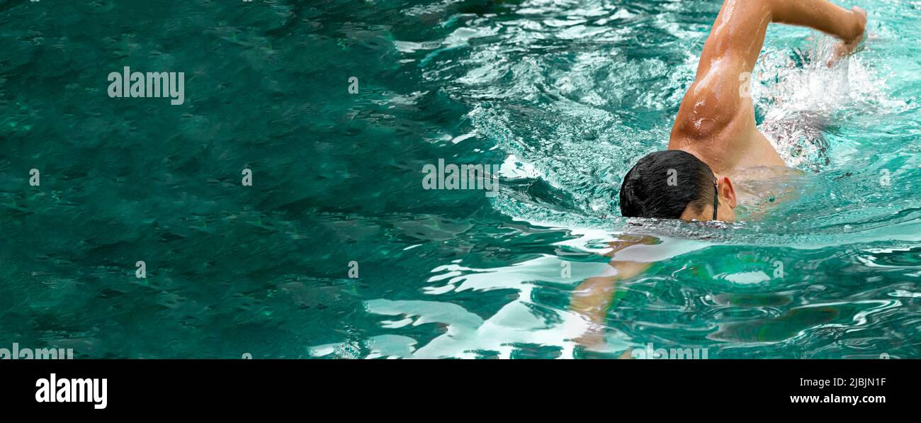 Man swimming with crawl in the pool. Triathlon fitness athlete swimming ...