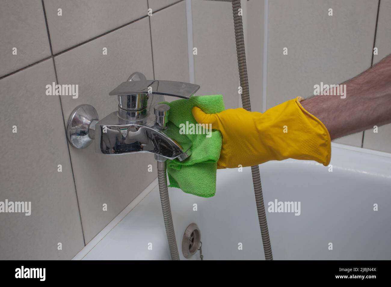 Cleaning tap from limescale in bathroom, disinfecting surface from ...