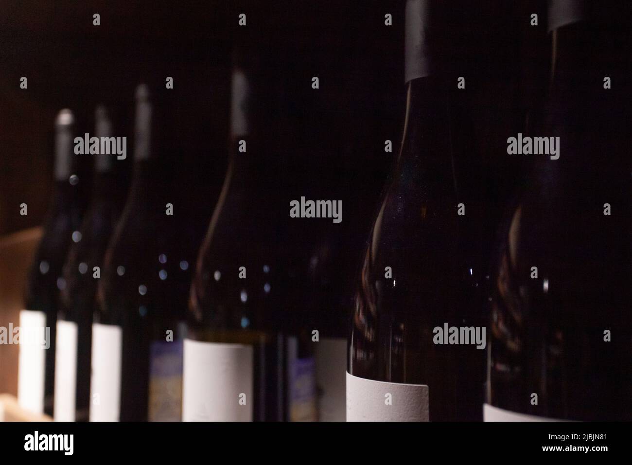 Elite wine bottles, dark wine background Stock Photo - Alamy