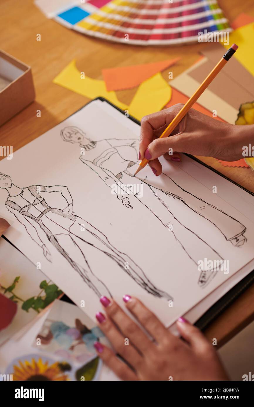 Hands of designer drawing fashion illustration at her desk Stock Photo ...