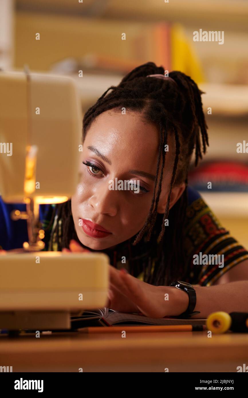 Seamstress trying to figure out why sewing machine does not work Stock ...