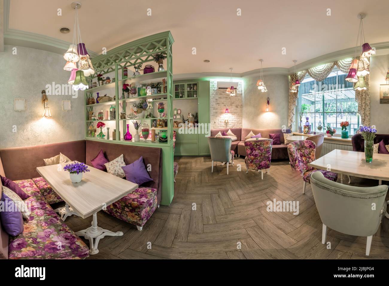 Cozy cafe interior with soft sofas and chairs, shelves with romantic ...