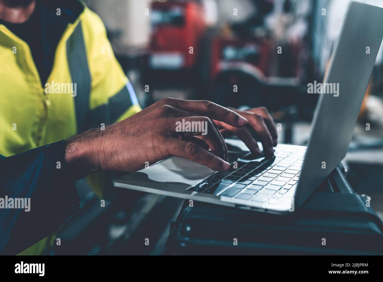 Factory worker working with laptop computer to do adept procedure ...