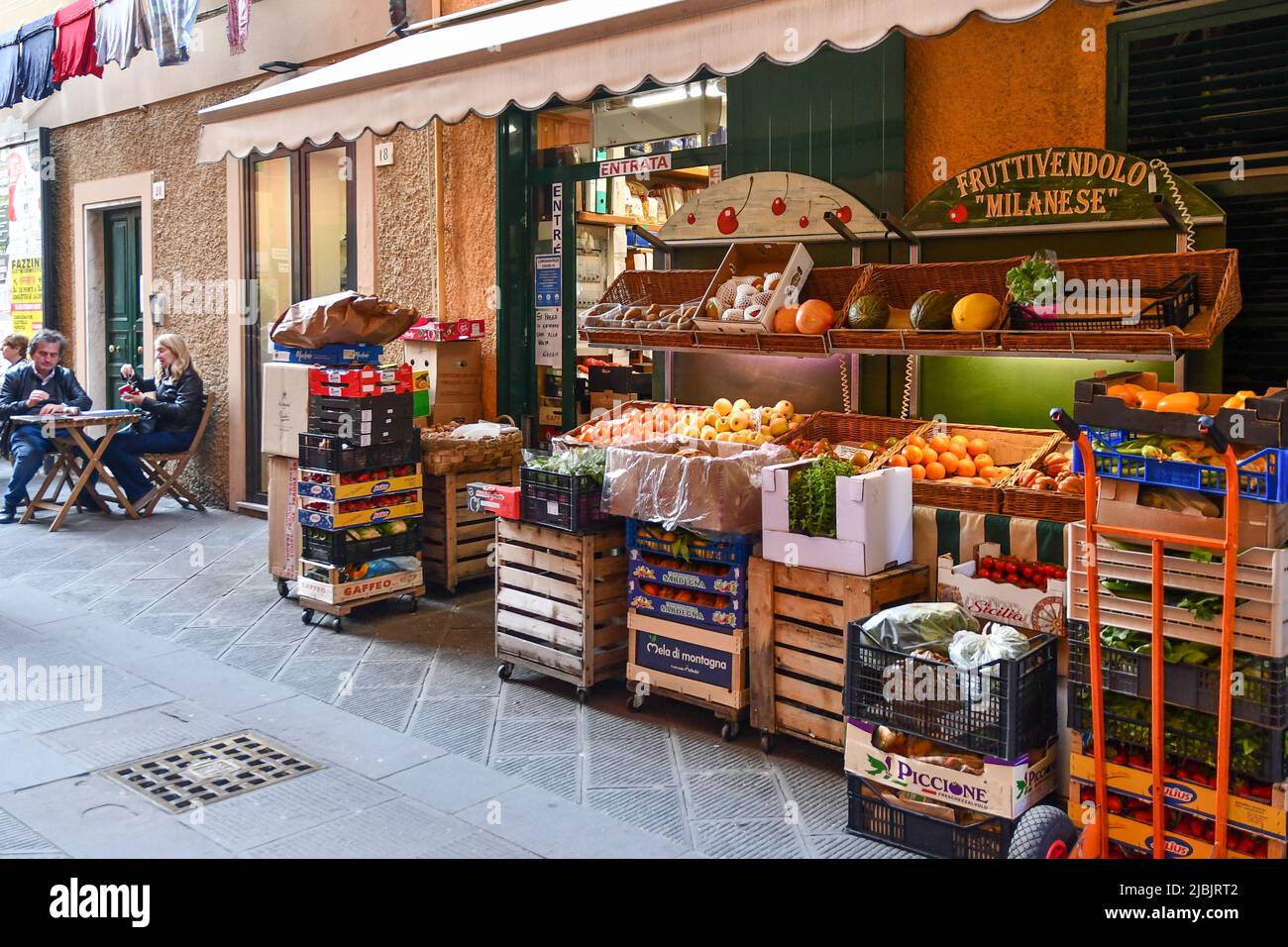 Exterior of grocery store with fruit boxes displayed on the sidewalk ...