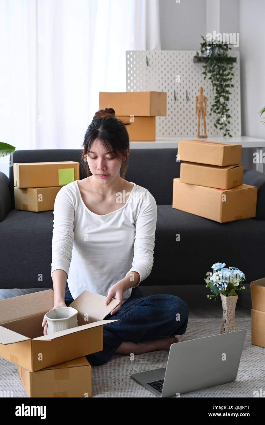 Startup small business entrepreneur packing parcel boxes for shipping ...