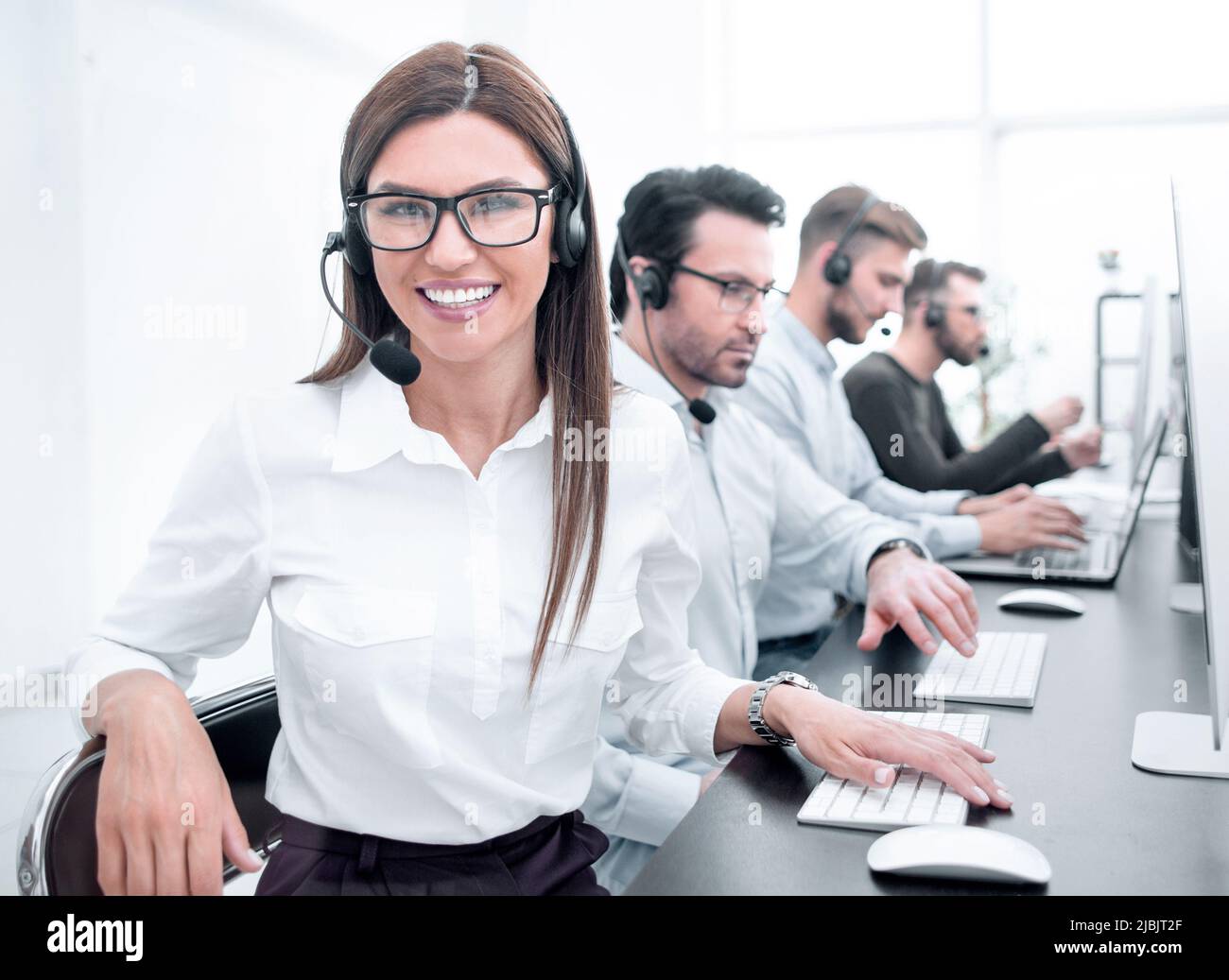 smiling call center employee works in a modern office Stock Photo - Alamy