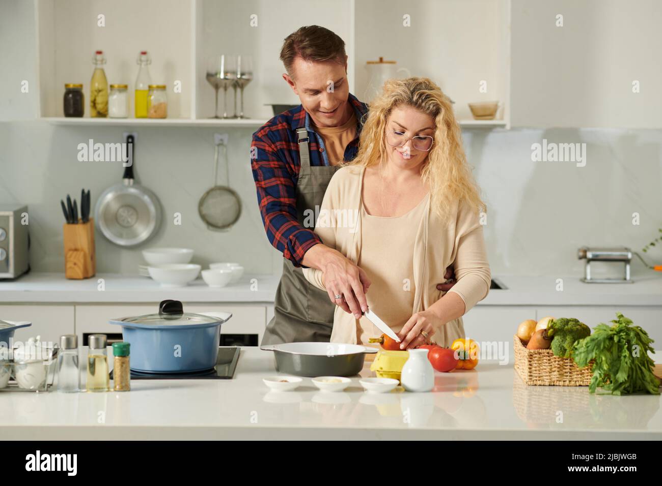Couple in love cooking dinner together in modern kitchen Stock Photo ...