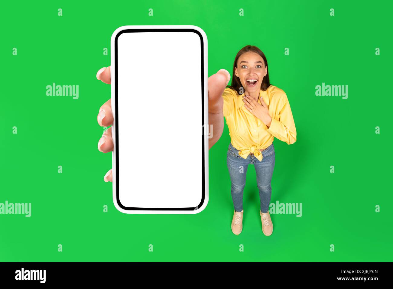 Excited Female Showing Big Cellphone Empty Screen Over Green Background ...