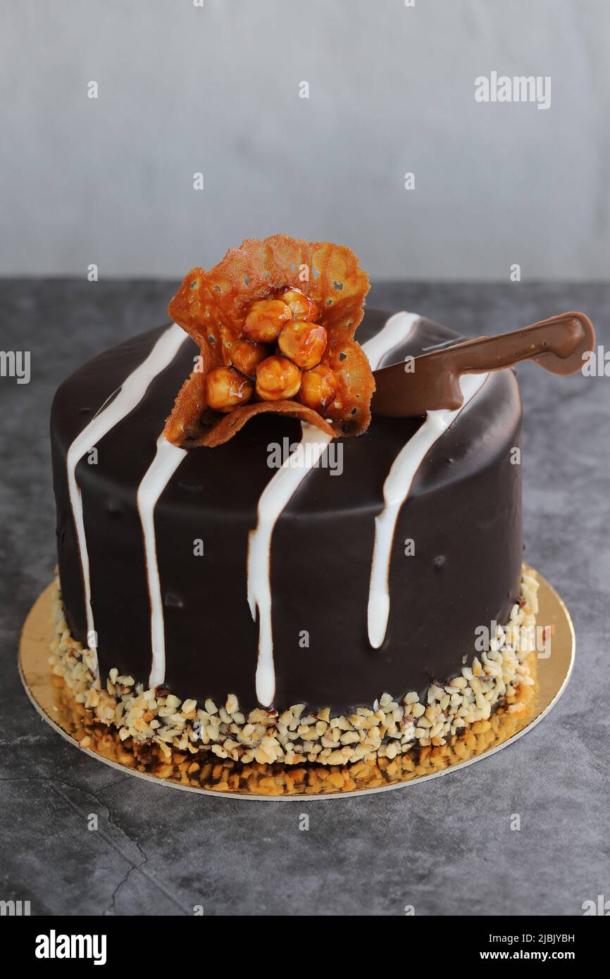 Chocolate and croquant cake. Celebratory cake on a dark background ...