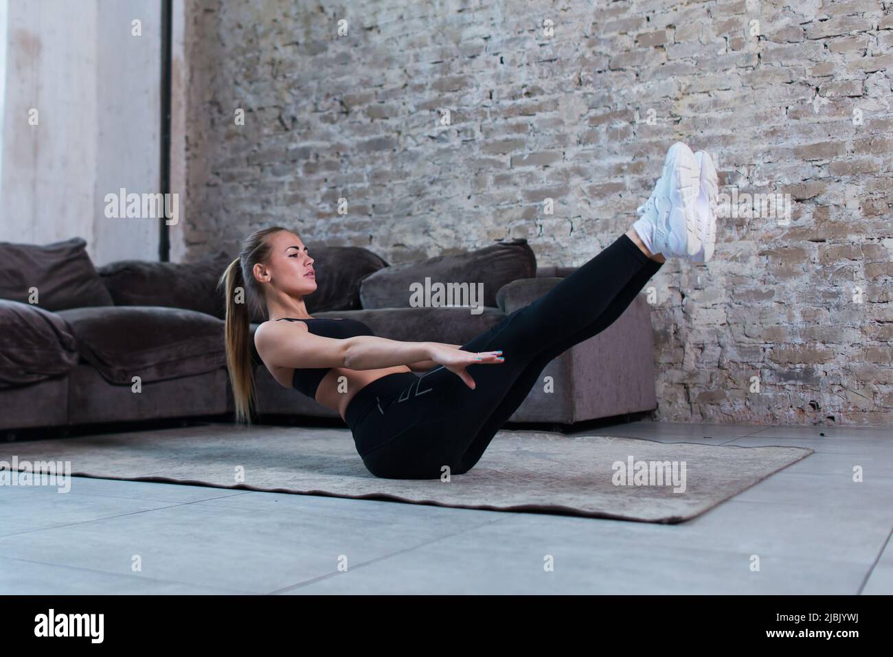 Female athlete doing static abs v hold exercise strengthening core ...