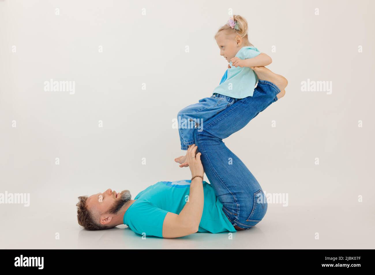 Young athletic man with pumped up arms lying on back holding and ...