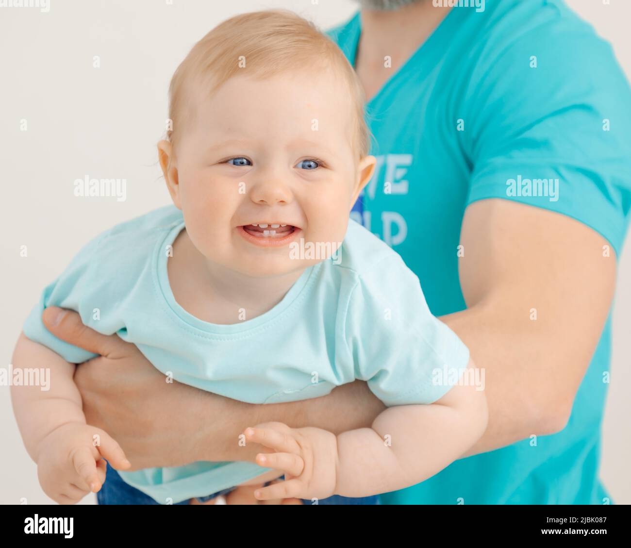 Slim man holding baby hi-res stock photography and images - Alamy